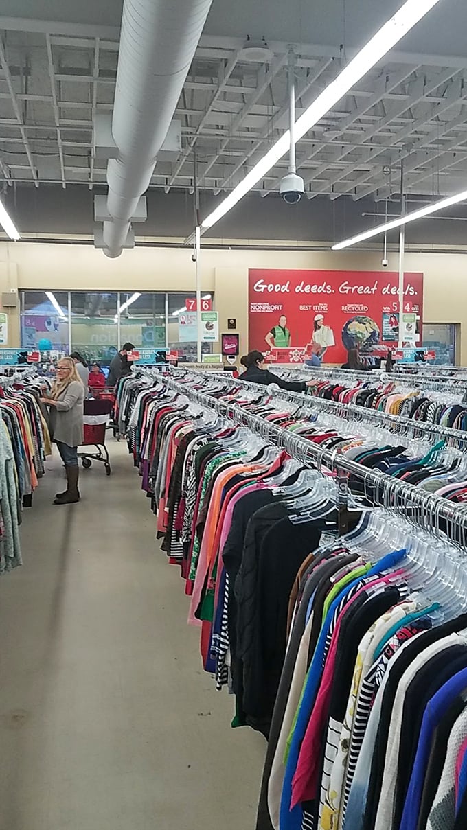 "Good deeds. Great deals." The sign says it all, while shoppers navigate the colorful clothing jungle with the focus of archaeologists on a dig.