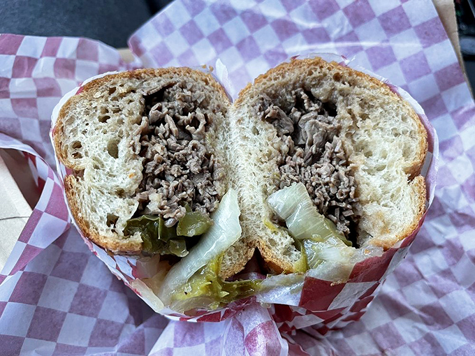 The cross-section reveals the truth: perfectly seasoned beef, tender enough to surrender at first bite, with peppers playing the perfect supporting role.