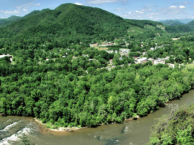 The French Broad River embraces the town like a protective parent, carving its ancient path through lush Appalachian wilderness.