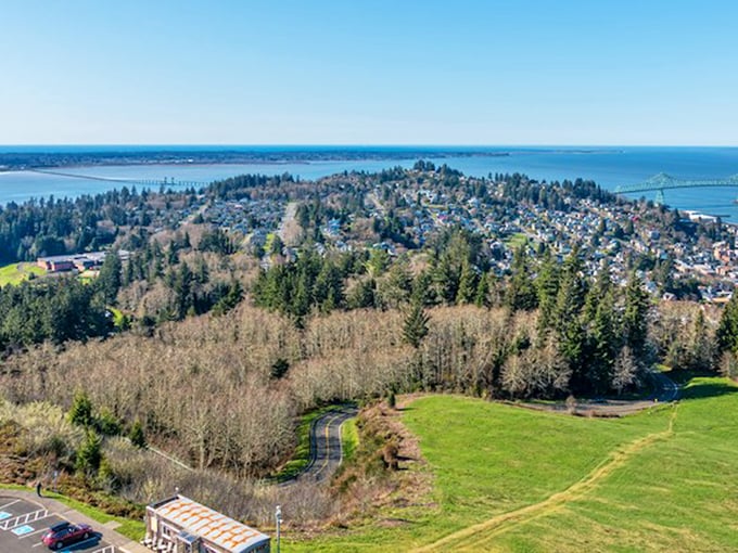 Aerial View: From above, Astoria reveals its perfect positioning&mdash;nestled between forest-covered hills and the mighty Columbia, with the iconic bridge standing guard.