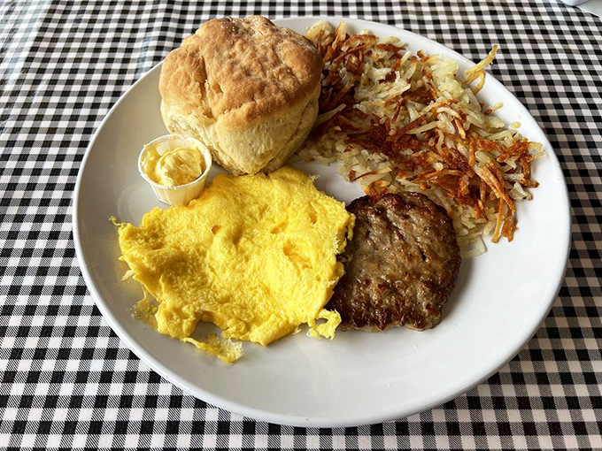 The holy trinity of breakfast: golden eggs, crispy hash browns, and a biscuit that would make your grandmother jealous.