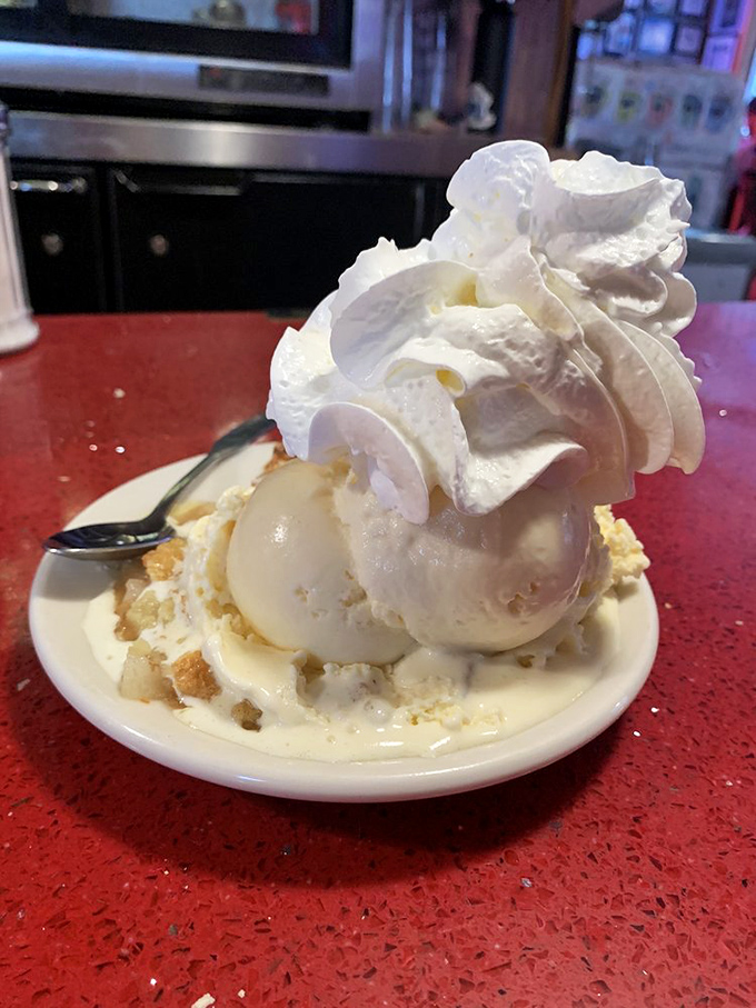 This isn't just dessert, it's architecture&mdash;a towering monument to whipped cream engineering atop what might be the world's most perfect ice cream sundae.