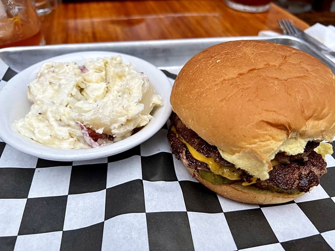 The classic Arnold burger with potato salad on a checkered paper&mdash;proof that perfection doesn't need fancy plating, just honest ingredients and know-how.