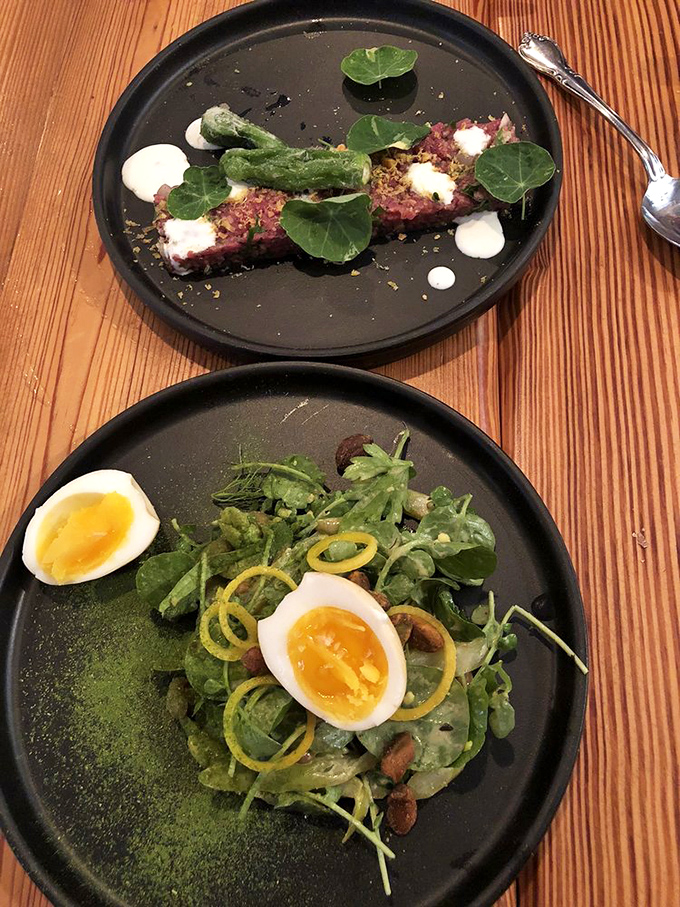 At Heirloom, even salads become an event worth photographing. Perfectly jammy eggs and vibrant greens share the spotlight with beef tartare that's dressed better than most people at the Oscars.