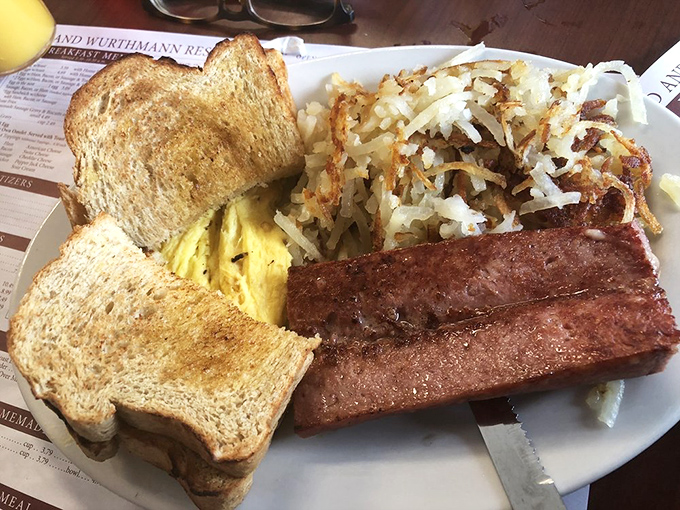 The breakfast plate that launched a thousand road trips: perfectly scrambled eggs, hash browns with actual personality, and toast that remembers what real butter tastes like.