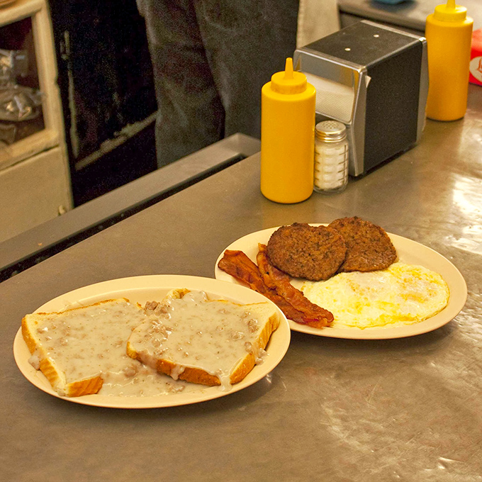 The holy trinity of breakfast&mdash;perfectly cooked eggs, savory sausage patties, and crisp bacon&mdash;displayed on a plate that's seen decades of satisfied smiles.
