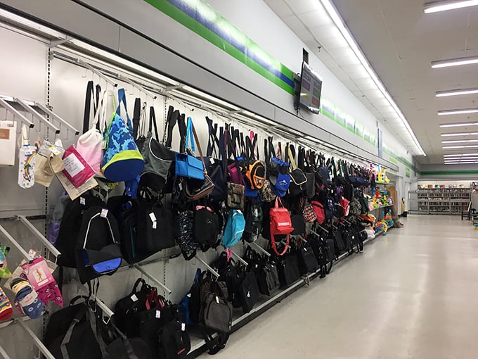 The handbag wall: where designer dreams meet bargain reality. More variety than my grandmother's collection of church purses.