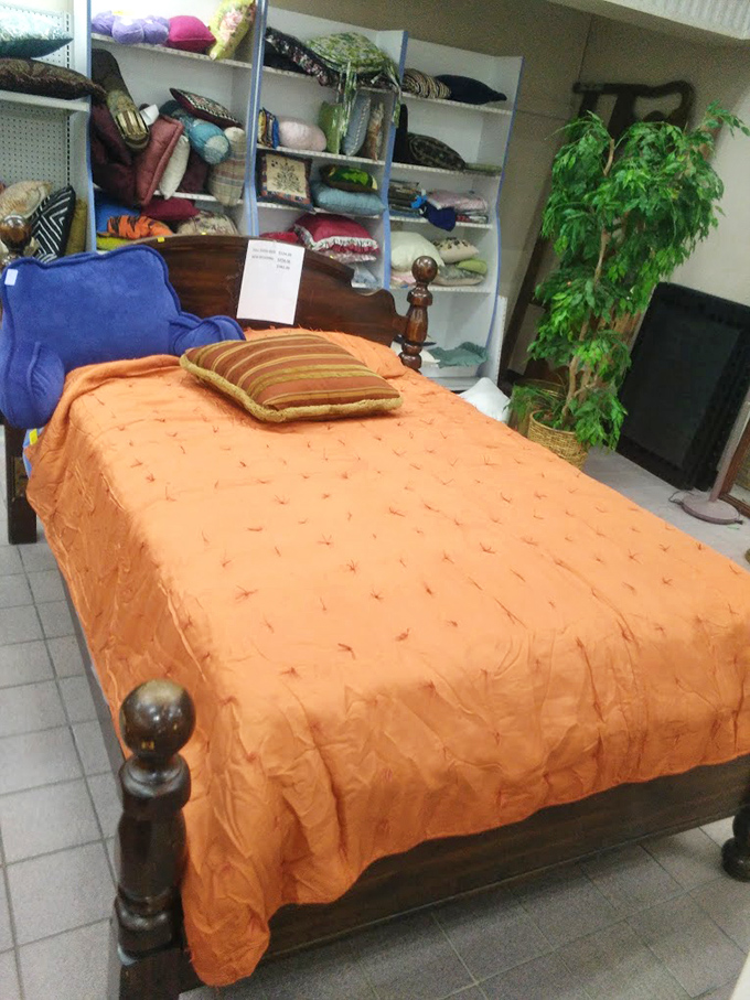 An orange bedspread that screams "1970s optimism" adorns a bed just waiting for its second act. Decorators call this look "nostalgic chic."