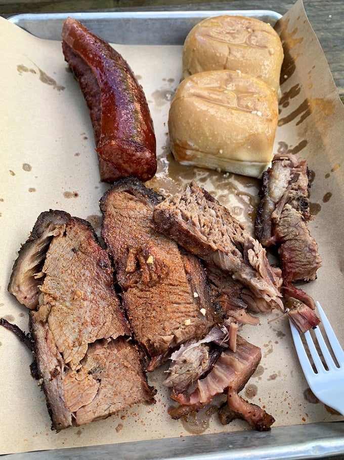 Brisket with that perfect smoke ring and a sausage link that snaps like the perfect punchline&mdash;this is barbecue poetry on a plate.