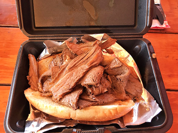 This isn't just a sandwich; it's an architectural marvel of tender brisket piled so high it deserves its own zip code.
