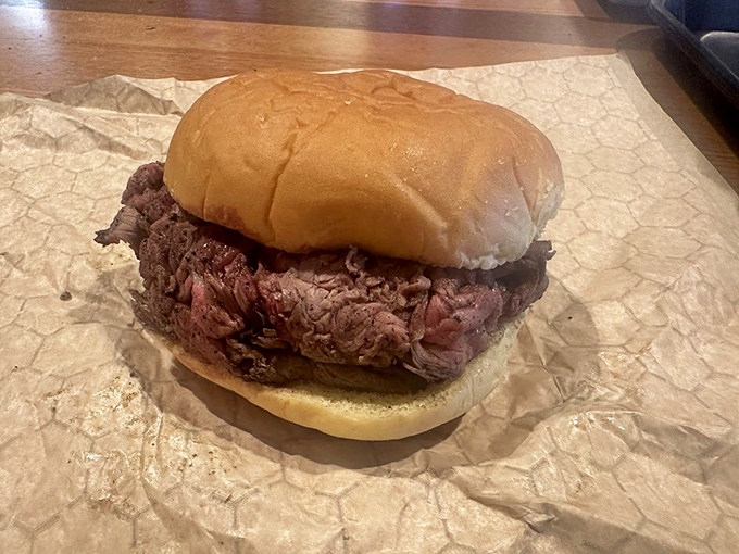 The star of the show: a mountain of rare pit beef on a humble kaiser roll, waiting to transform your understanding of what barbecue can be.