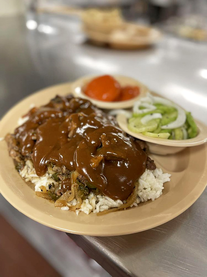 These beef tips aren't playing around. Smothered in rich gravy atop a mountain of rice, with cucumber slices pretending this meal has any restraint.