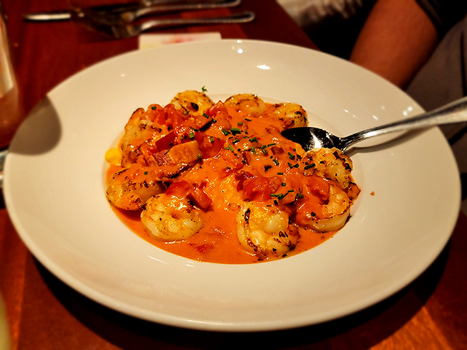 Each plump shrimp sits atop a golden pool of cheesy grits like royalty, while the sauce performs a perfect balancing act between spicy and savory.