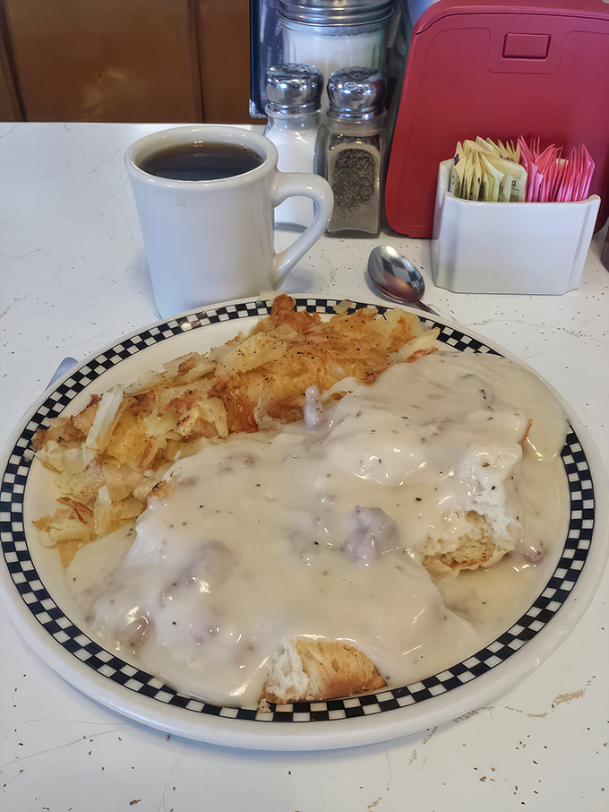 This isn't just biscuits and gravy; it's a warm hug on a plate, with creamy sausage gravy cascading over fresh-baked goodness.