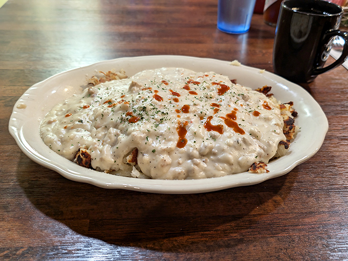 This isn't just gravy&mdash;it's a warm blanket of comfort covering a landscape of crispy potatoes. The kind of breakfast that makes you want to take a nap immediately after finishing.