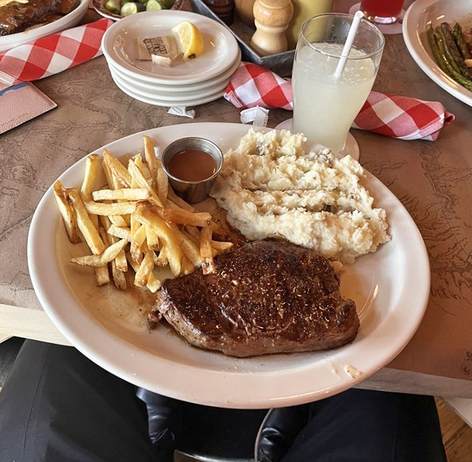 The perfect trifecta: a juicy steak, golden fries, and garlic mashed potatoes that'll have you contemplating whether licking the plate is socially acceptable.
