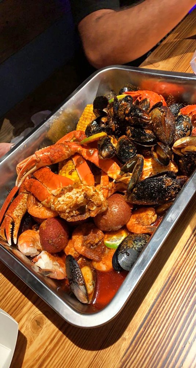 A treasure chest of oceanic delights: crab legs, mussels, and corn swimming in seasoned sauce. Neptune himself would approve of this bounty.