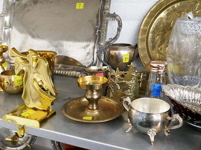 Vintage brass and silver treasures glimmer under fluorescent lights. Hollywood set designers would pay ten times these prices for such authentic character pieces.