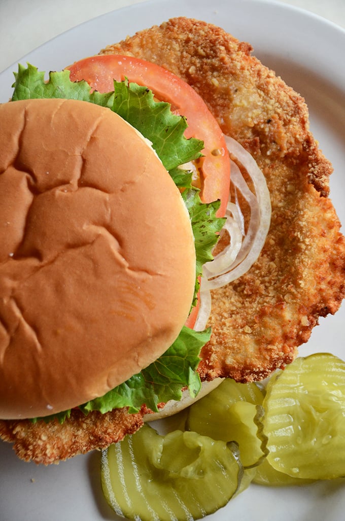 That tenderloin isn't just hanging off the bun – it's making a statement that bigger is better when it comes to Indiana's signature sandwich.