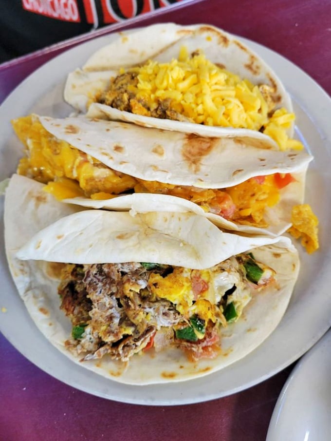 Breakfast tacos stacked like delicious poker chips, ready to call your hunger's bluff. Each tortilla cradles a different morning masterpiece waiting to be discovered.