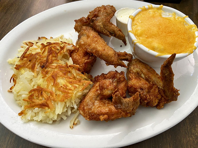 Fried chicken wings with the crispiness level set to "perfect" &ndash; paired with hash browns that look like they've been practicing their golden tan.