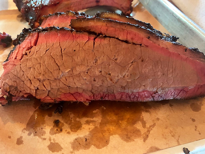 The holy grail of barbecue: perfectly smoked brisket with that coveted pink smoke ring that whispers, "Yes, they know exactly what they're doing."
