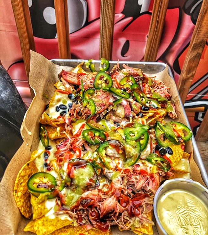 These nachos aren't messing around&mdash;they've got more layers than a winter wardrobe in Minnesota. That green chili queso is practically doing a victory lap around those chips.