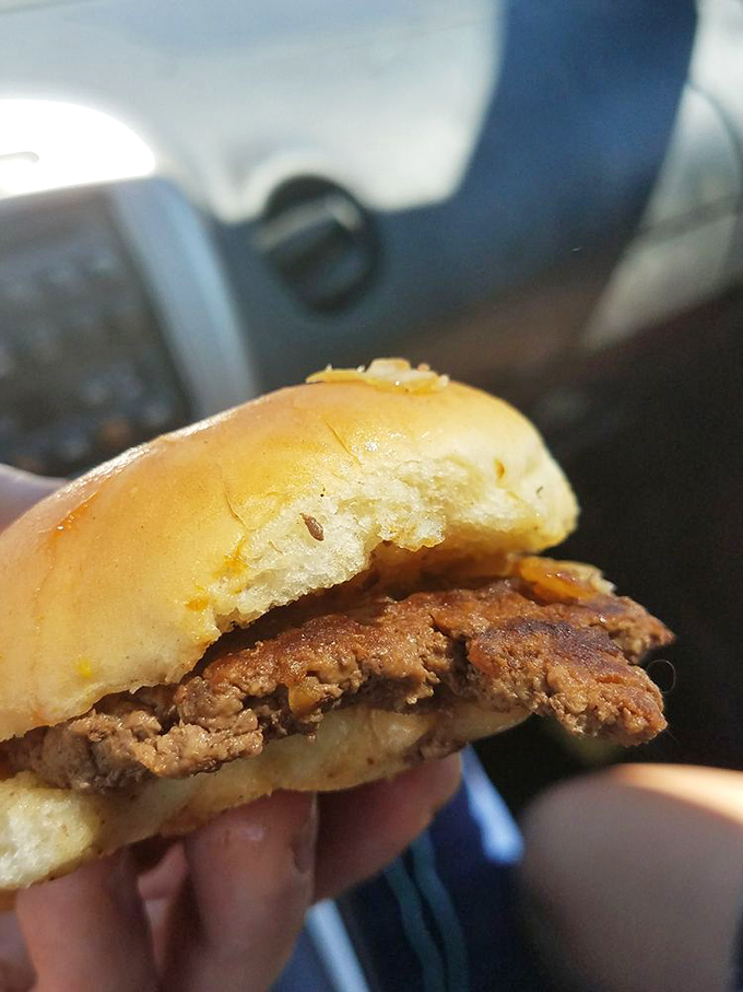 Behold the cross-section of perfection—a thin patty with caramelized onions pressed right into the beef, nestled in a pillowy bun.