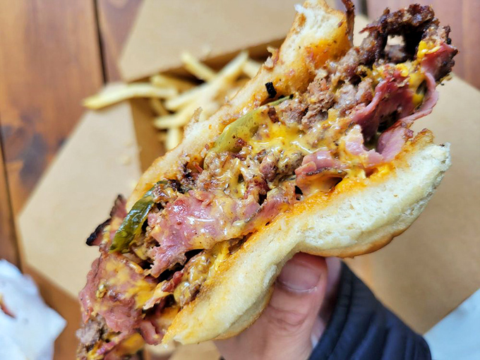 The perfect burger cross-section reveals the truth: a harmonious marriage of crispy-edged beef, melty cheese, and a soft bun. Food poetry in handheld form.