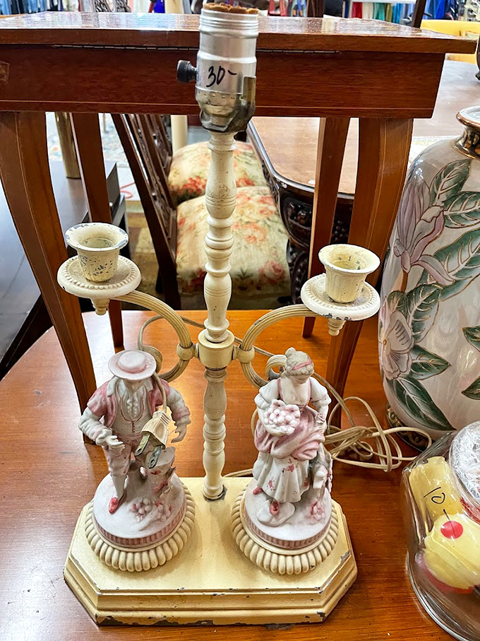 This vintage candelabra with porcelain figurines isn't just a lamp – it's someone's grandmother's prized possession waiting for its second act.