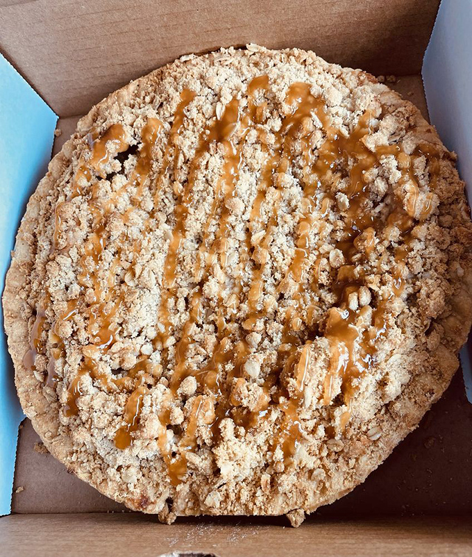 Caramel drizzled over crumble topping like nature's own topographic map of deliciousness. Geography never tasted so good.