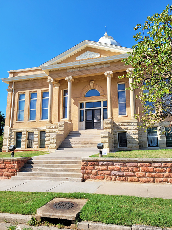 The Carnegie Library stands as a temple to knowledge, its classical columns and dome reminding us that frontier towns valued books as much as bullets.