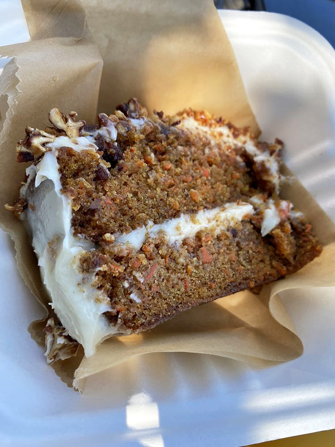 The cross-section reveals the truth &ndash; visible carrot shreds, perfect spice distribution, and a frosting-to-cake ratio that deserves scientific study.