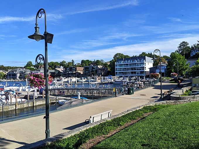 The marina walkway offers front-row seats to Charlevoix's nautical parade, where boats glide by like celebrities on a watery red carpet.