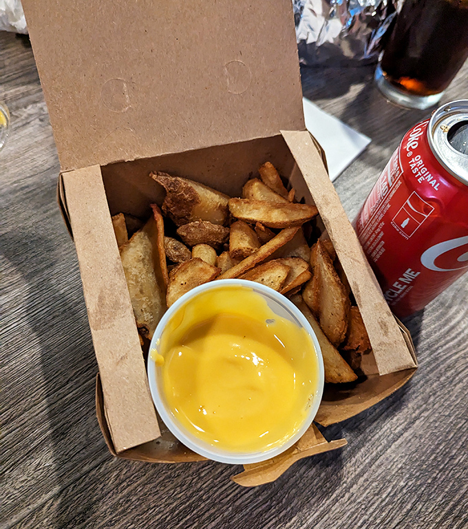 These aren't your average fries&mdash;they're supporting actors deserving of their own spotlight. The cheese sauce beckons like a golden pool of happiness.
