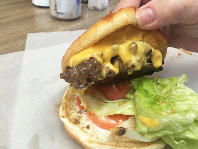 The anatomy of perfection: Thick beef patty, Ashe County cheddar melted to divine consistency, and fresh toppings on a simple bun.