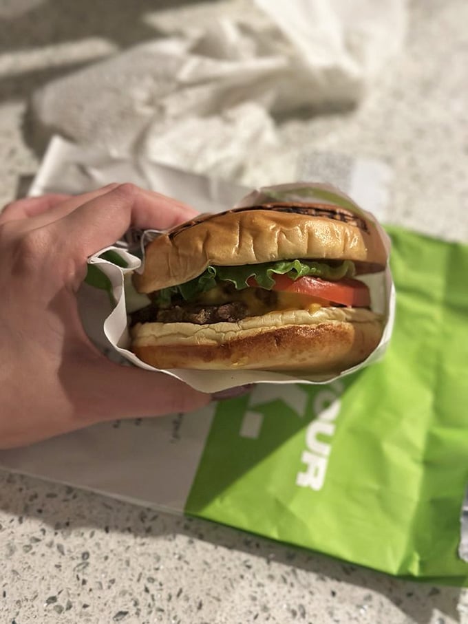 Behold the perfect burger cross-section: juicy patty, melty cheese, fresh veggies, and a bun that's somehow both sturdy and tender&mdash;architectural perfection in food form.