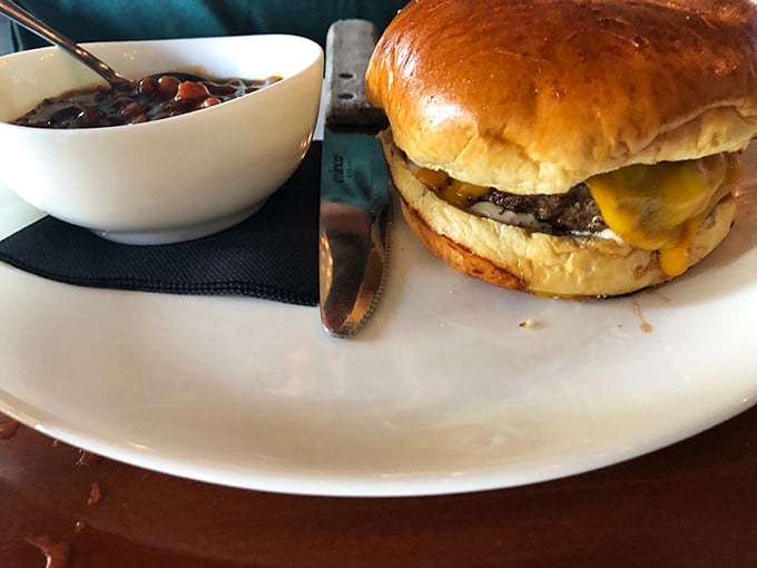 This classic cheeseburger with a side of baked beans proves that sometimes the simplest combinations deliver the most profound satisfaction.