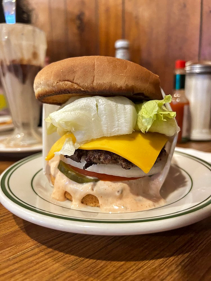 Behold the star of the show! That perfectly melted cheese, crisp lettuce, and signature Thousand Island dressing create a burger symphony that Mozart would envy.