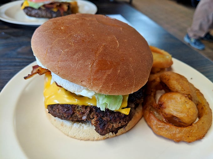 The perfect plate doesn't exi— Oh wait, there it is: a juicy burger with cheese melting just right, accompanied by golden onion rings.