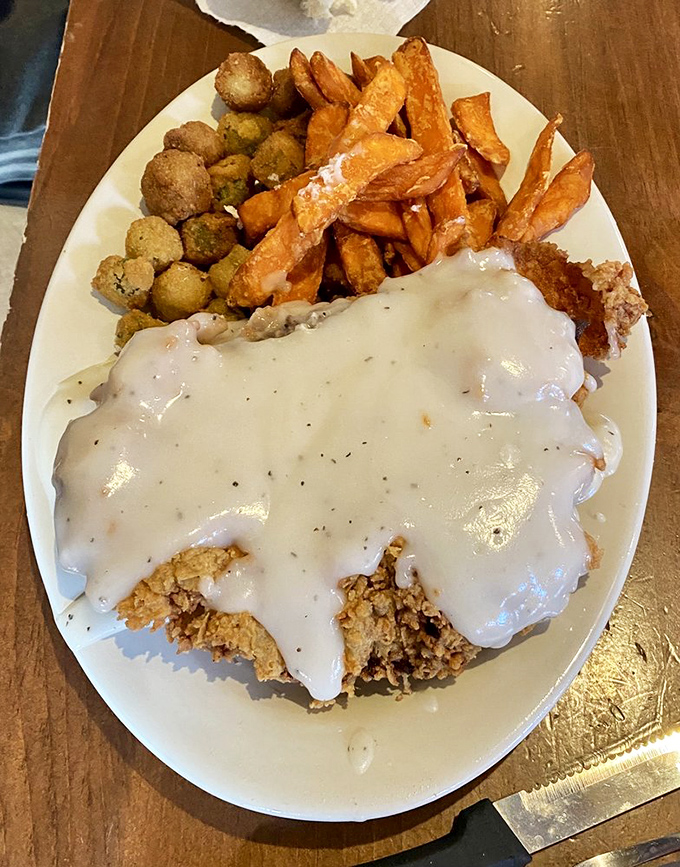 Chicken fried steak smothered in gravy alongside sweet potato fries and fried okra&mdash;the holy trinity of comfort food that makes cardiologists wince and souls sing.