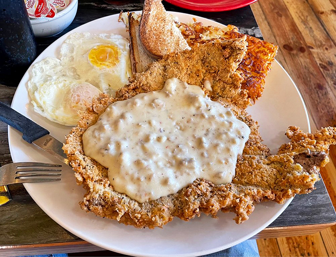 This chicken fried steak with gravy isn't merely food&mdash;it's architecture. The crispy exterior gives way to tender meat beneath, like comfort on a plate.