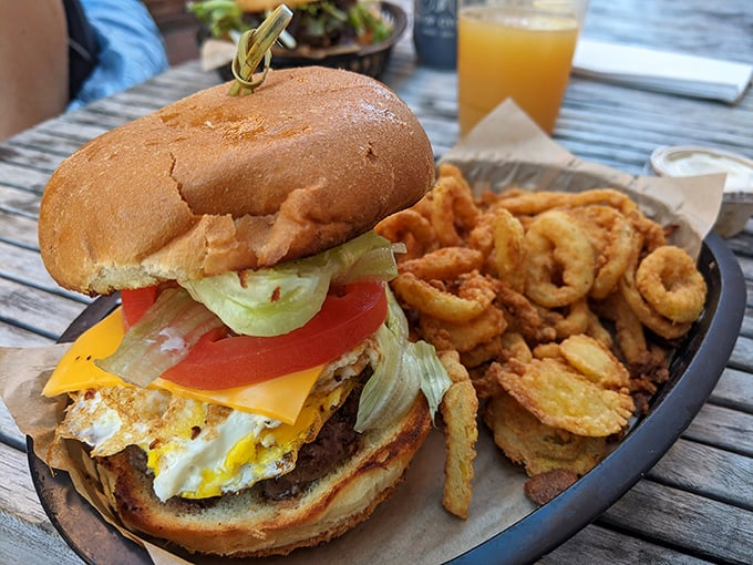 The Fried Egg Burger arrives like a sunrise on a plate, complete with golden onion rings that shatter with a satisfying crunch between your teeth.