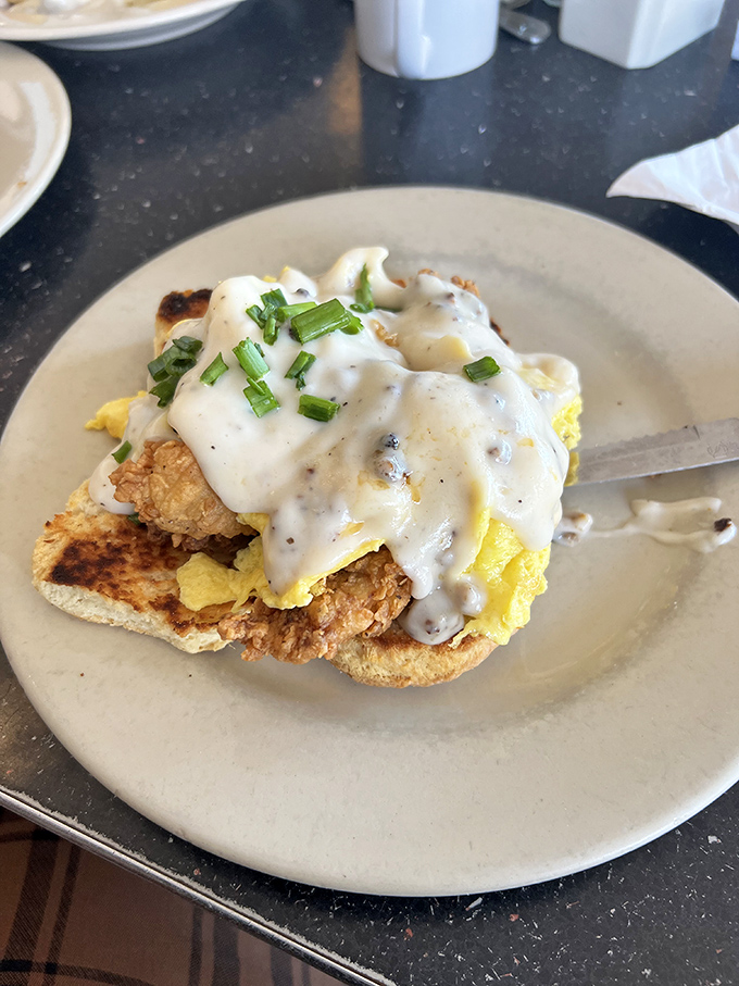 Southern comfort on a plate&mdash;crispy chicken nestled under creamy gravy with a sprinkle of chives. This isn't just breakfast; it's an edible hug.