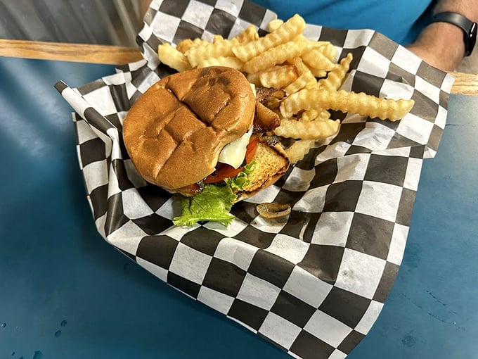 The burger that launched a thousand napkins. Served on a checkered paper that's seen more winners than the nearby track's finish line.