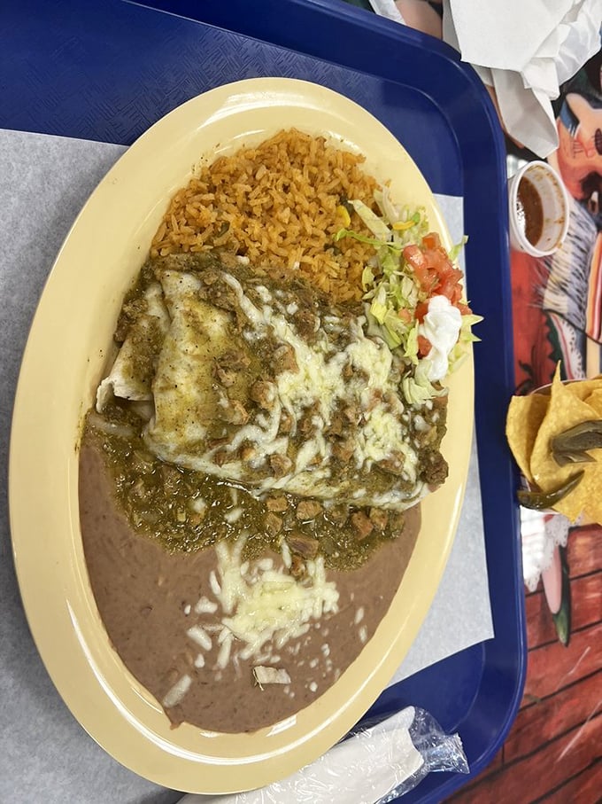 The holy trinity of Mexican comfort: perfectly seasoned chile verde, fluffy orange rice, and beans that could make a convert out of anyone.