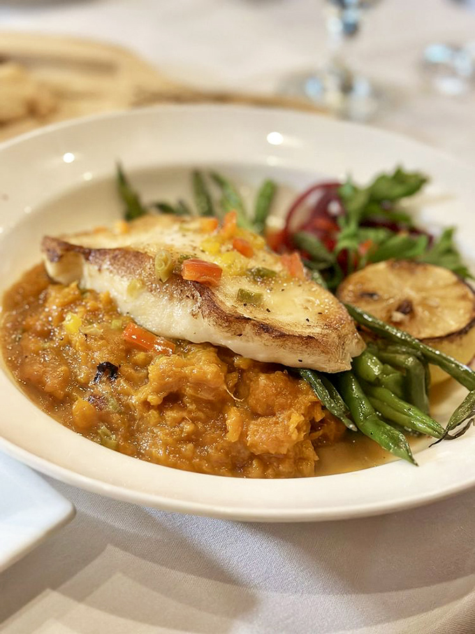 This Chilean sea bass doesn't just sit on the plate&mdash;it lounges luxuriously atop a risotto throne, surrounded by a vegetable entourage.