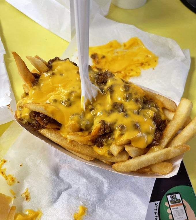 Chili cheese fries that demand both fork and commitment. The perfect marriage of crispy potatoes, savory chili, and melty cheese.