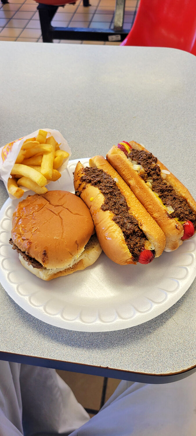 The holy trinity of roadside dining: golden fries, a classic burger, and two chili dogs that make you question why you'd eat hot dogs anywhere else.