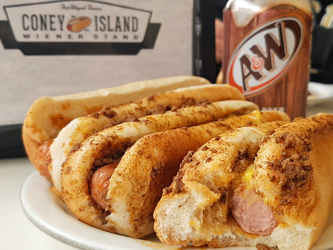 The holy trinity of comfort: two perfectly dressed Coney dogs, a cold A&W, and the knowledge that some pleasures never need upgrading.
